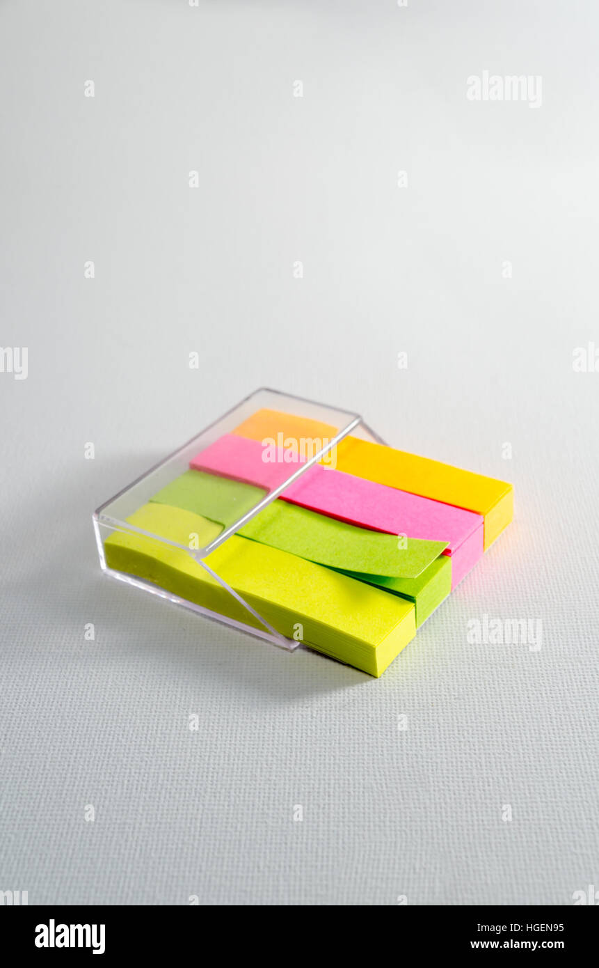 A Studio Photograph of Fluorescent Sticky Notes Housed Within a Plastic ...