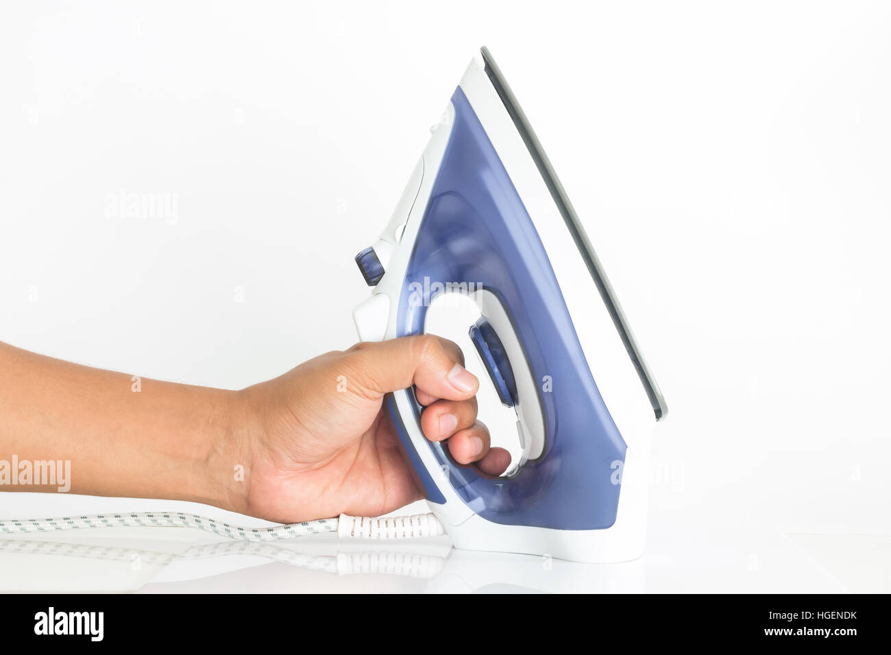 man's hand holding iron on white background Stock Photo - Alamy