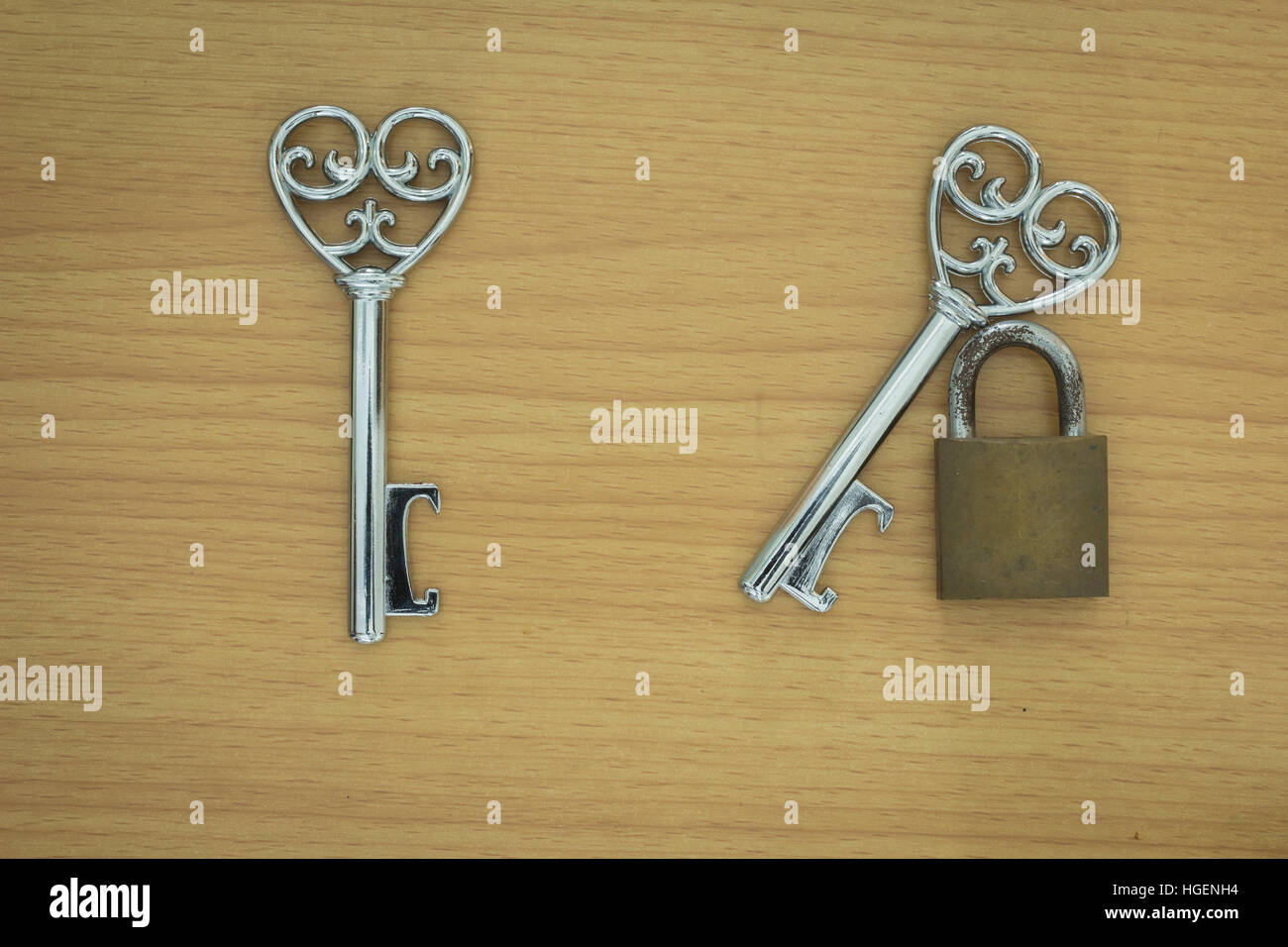Key with a heart inside and lock on wood background Stock Photo - Alamy