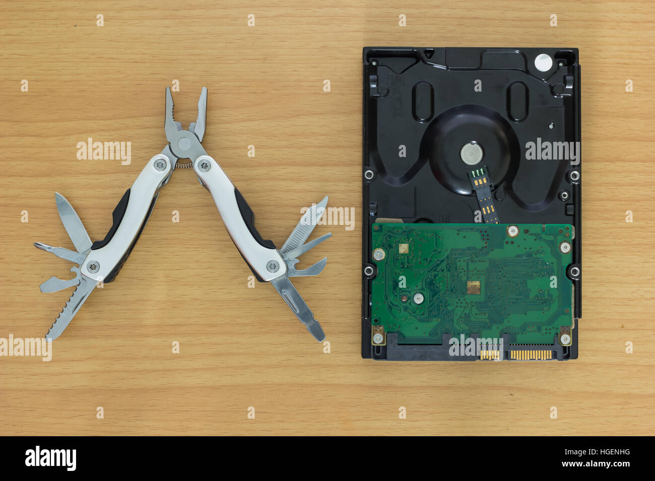 multipurpose pocket knife and Computer hard drive on wooden background ...