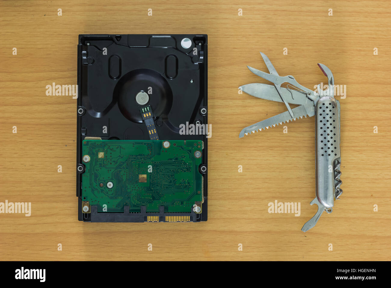 multipurpose pocket knife and Computer hard drive on wooden background ...