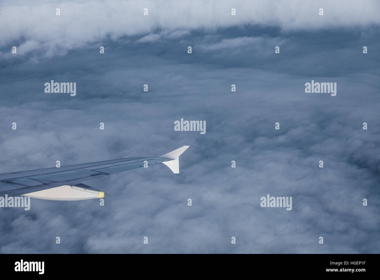 Aircraft banking into cloud layers on approach to LHR Stock Photo - Alamy