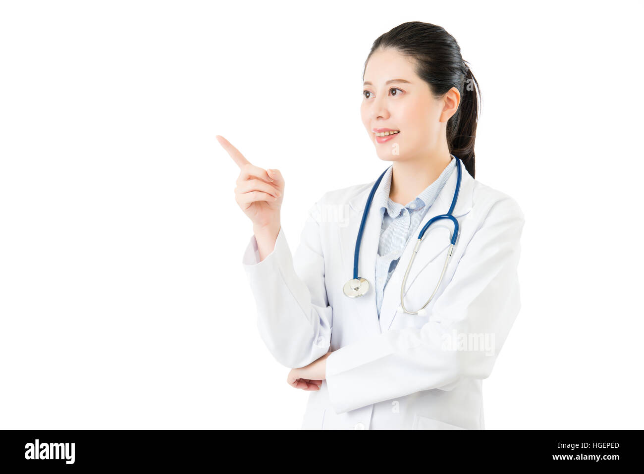 Happy beautiful female doctor point gesture blank area or copyspace ...