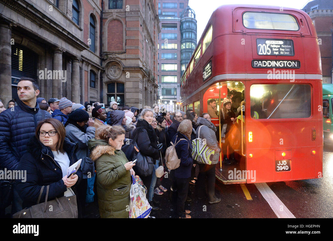 People queue for buses at Bishopsgate in the City of London, as ...