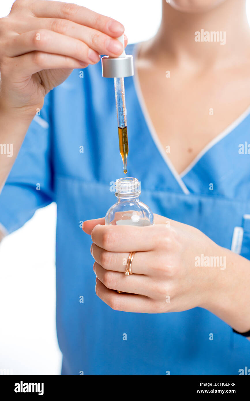 Cosmetologist with medical dropper Stock Photo - Alamy