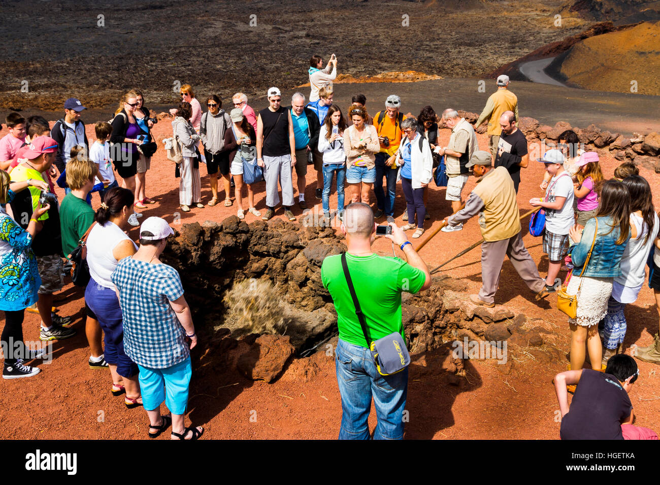 Tourists in a volcanic area Stock Photo - Alamy