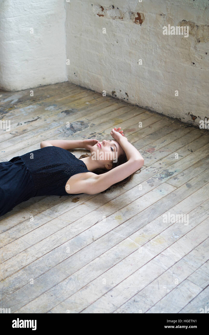 Depressed woman laying down on the floor Stock Photo - Alamy