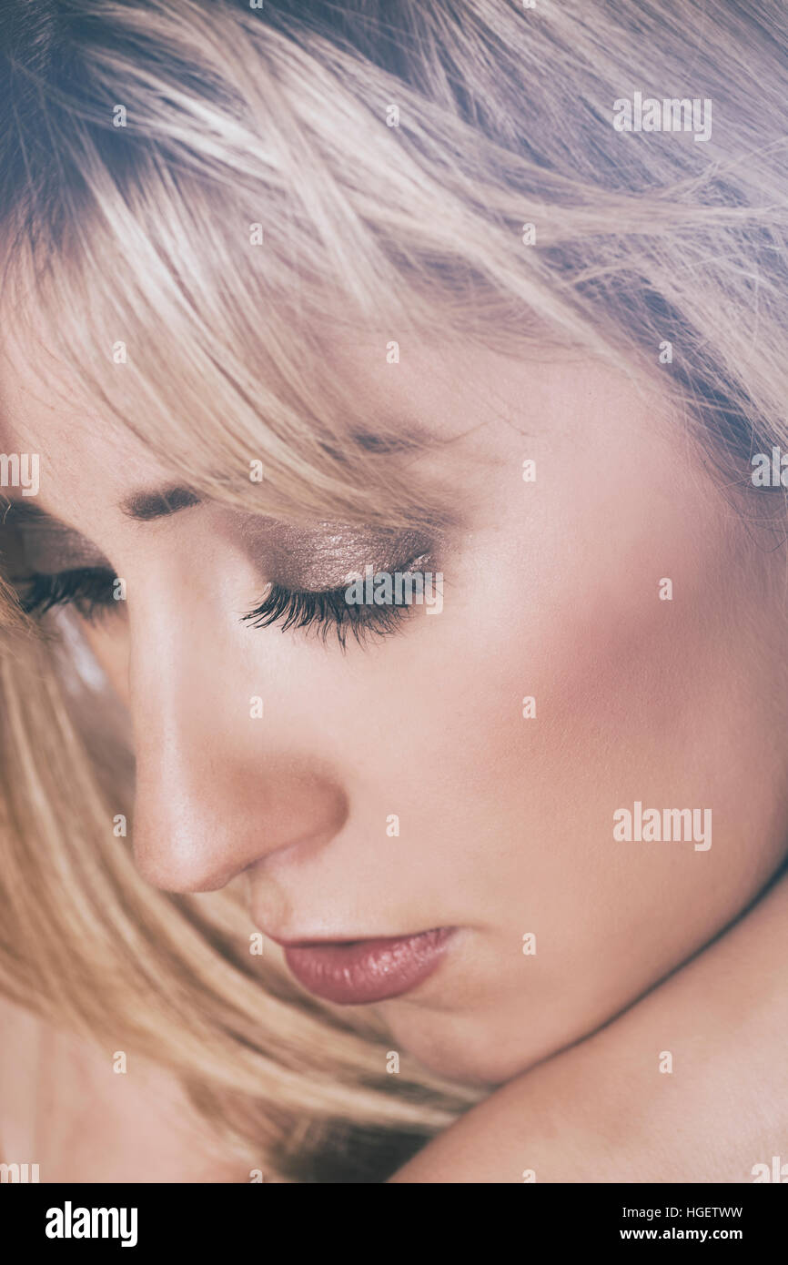 Is looking down with a thoughtful expression hi-res stock photography ...