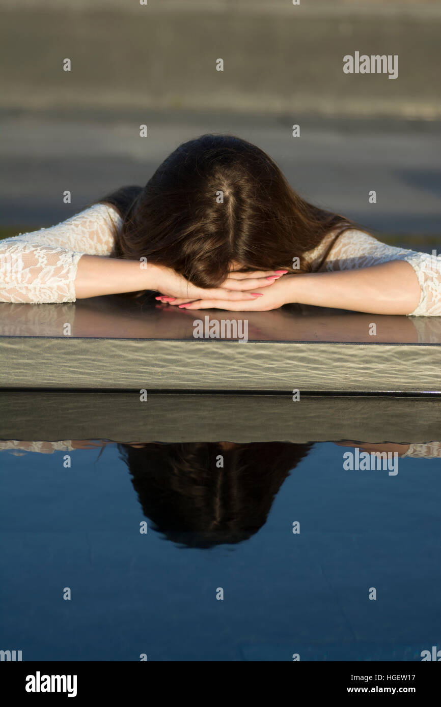 Sad woman head in hands outdoors Stock Photo - Alamy