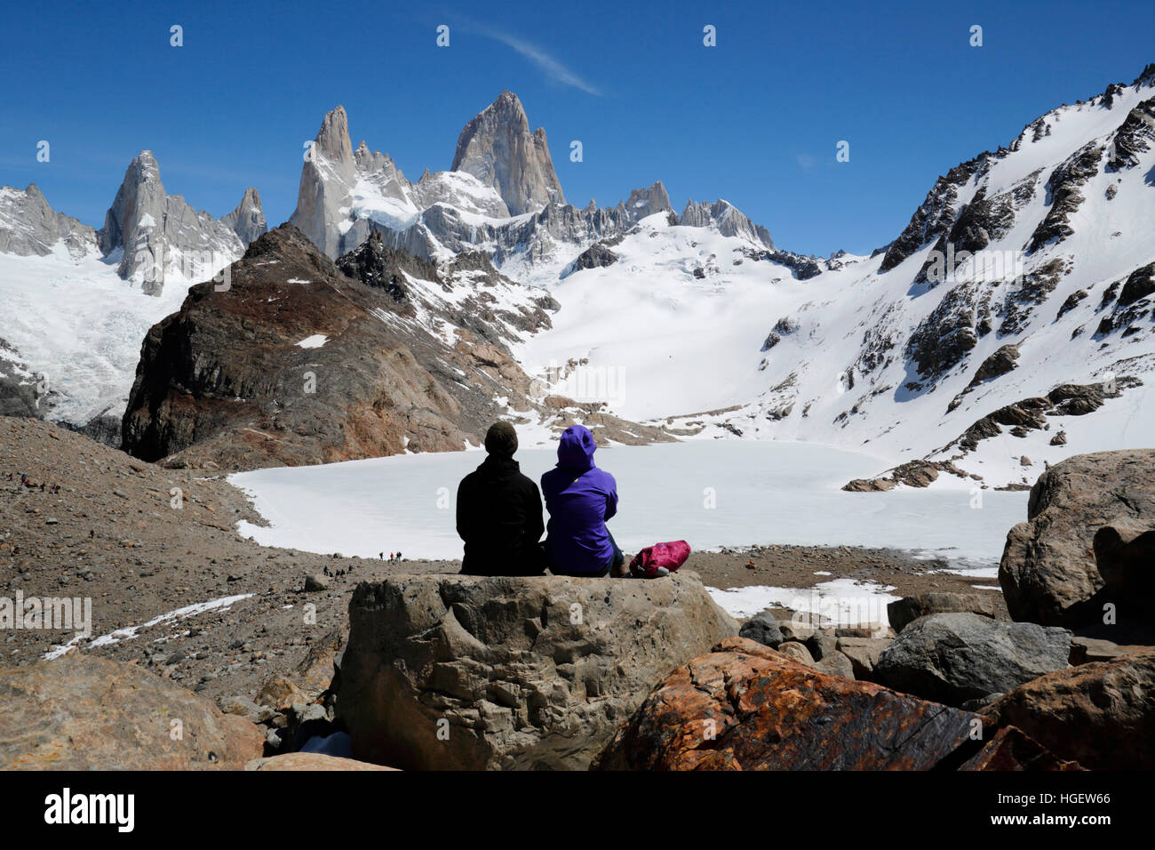 Hikers above Laguna de los Tres with view of Mount Fitz Roy, El Chalten ...