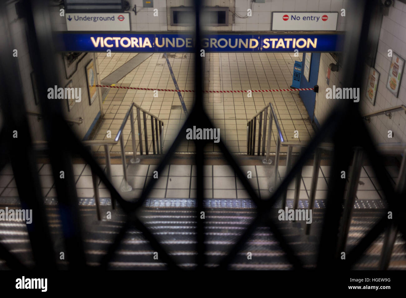 Looking through closed station gates at an empty Victoria station ...