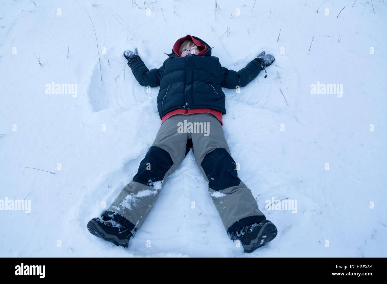 boy making snow angel near Winterberg, Sauerland, Northrhine Westfalia ...