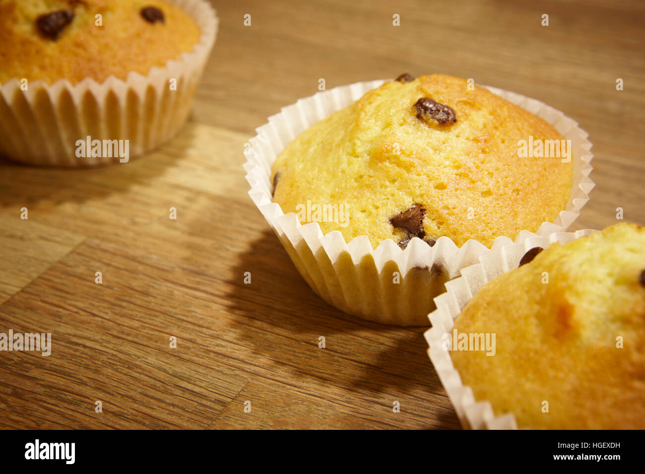 Cupcakes with chocolate in horizontal format. Wooden table. Background ...