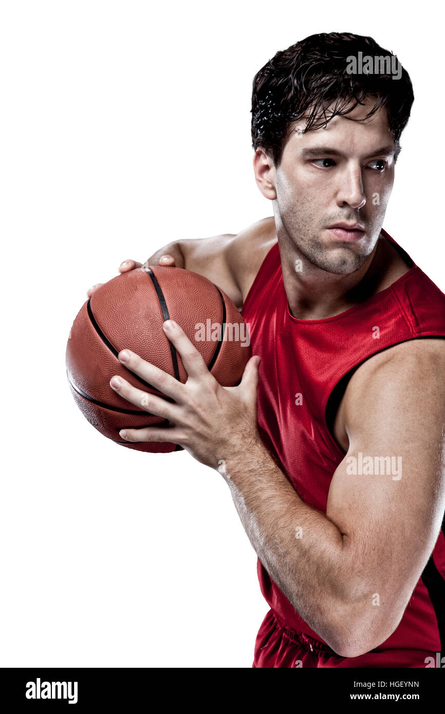 Basketball player with a ball in his hands and a red uniform. On a ...