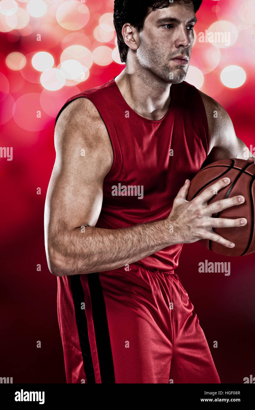 Basketball player on a red uniform, on a red lights backgrond Stock ...