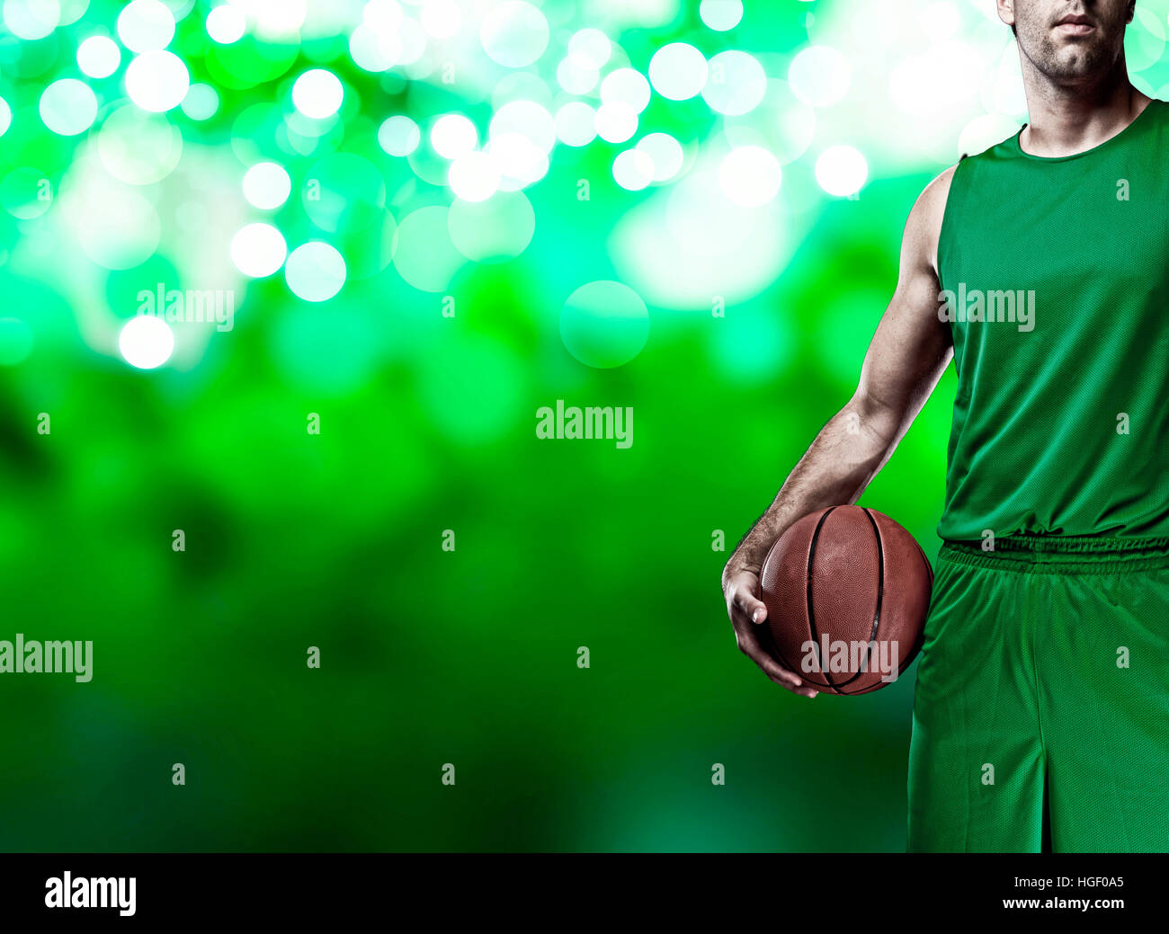 Basketball player on a green uniform, on a green lights backgrond Stock ...