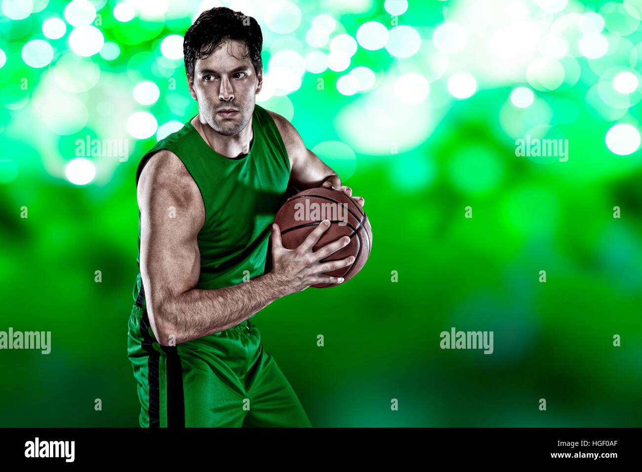 Basketball player on a green uniform, on a green lights backgrond Stock ...
