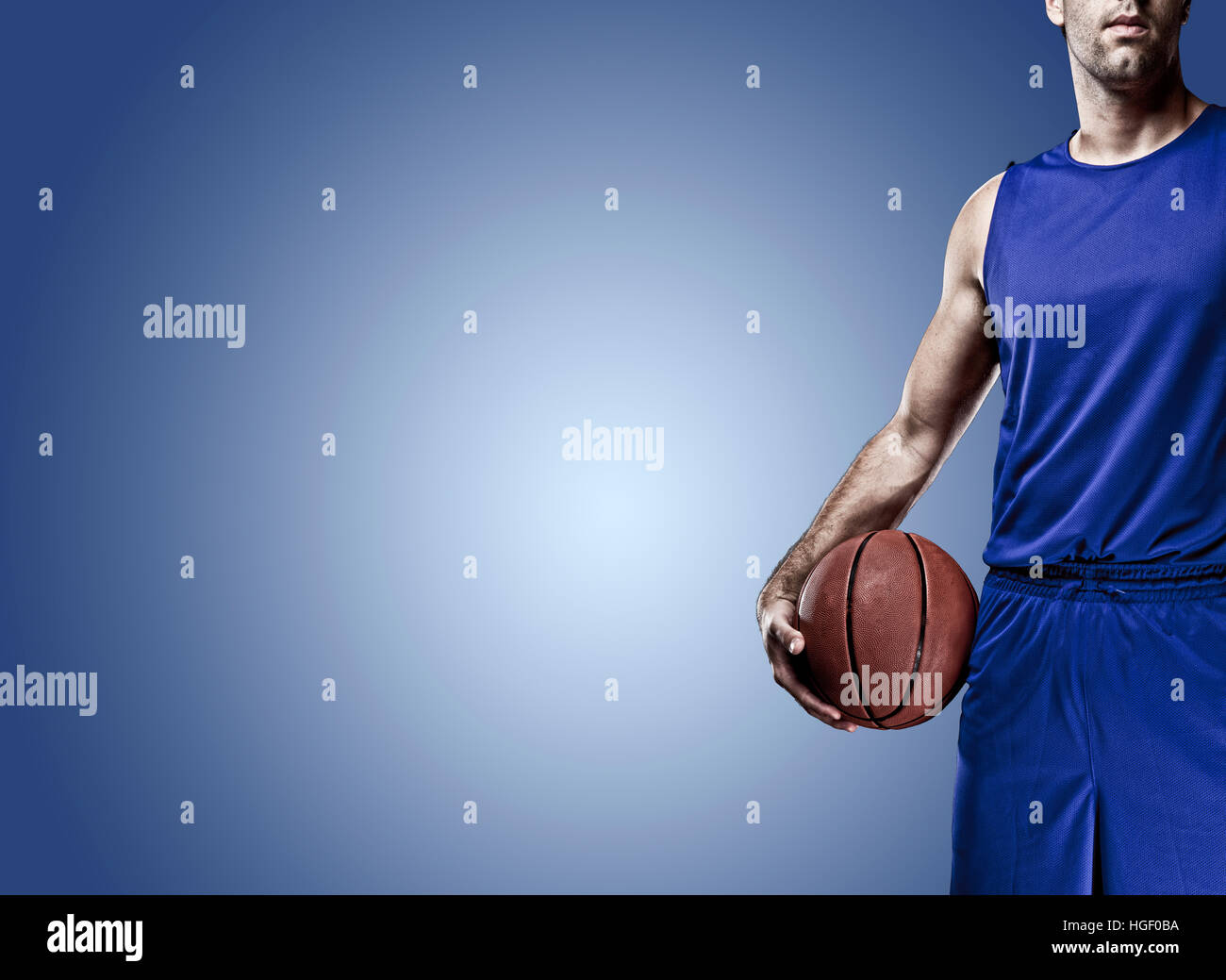 Basketball player on a blue uniform, on a blue background Stock Photo ...