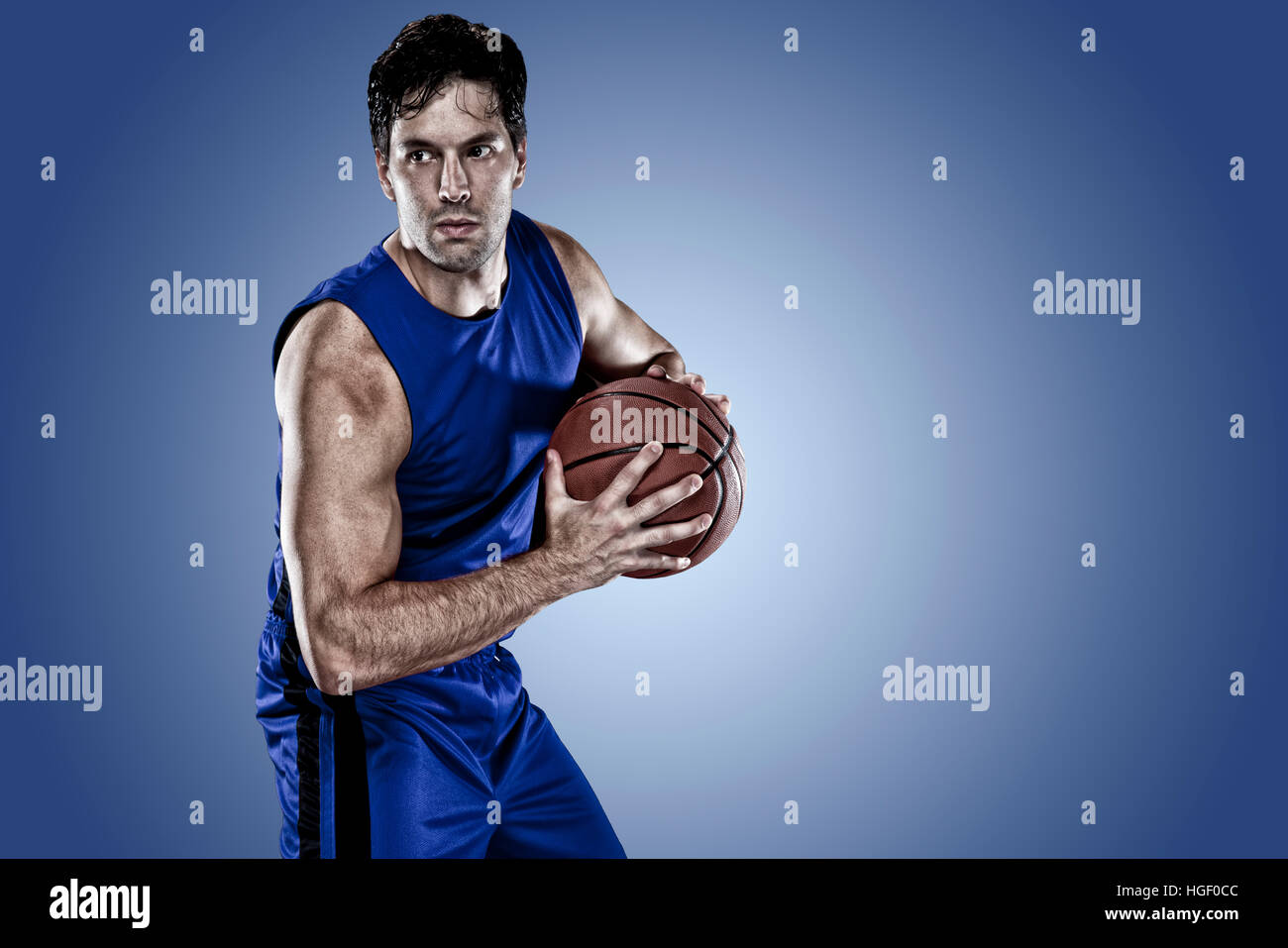 Basketball player on a blue uniform, on a blue background Stock Photo ...