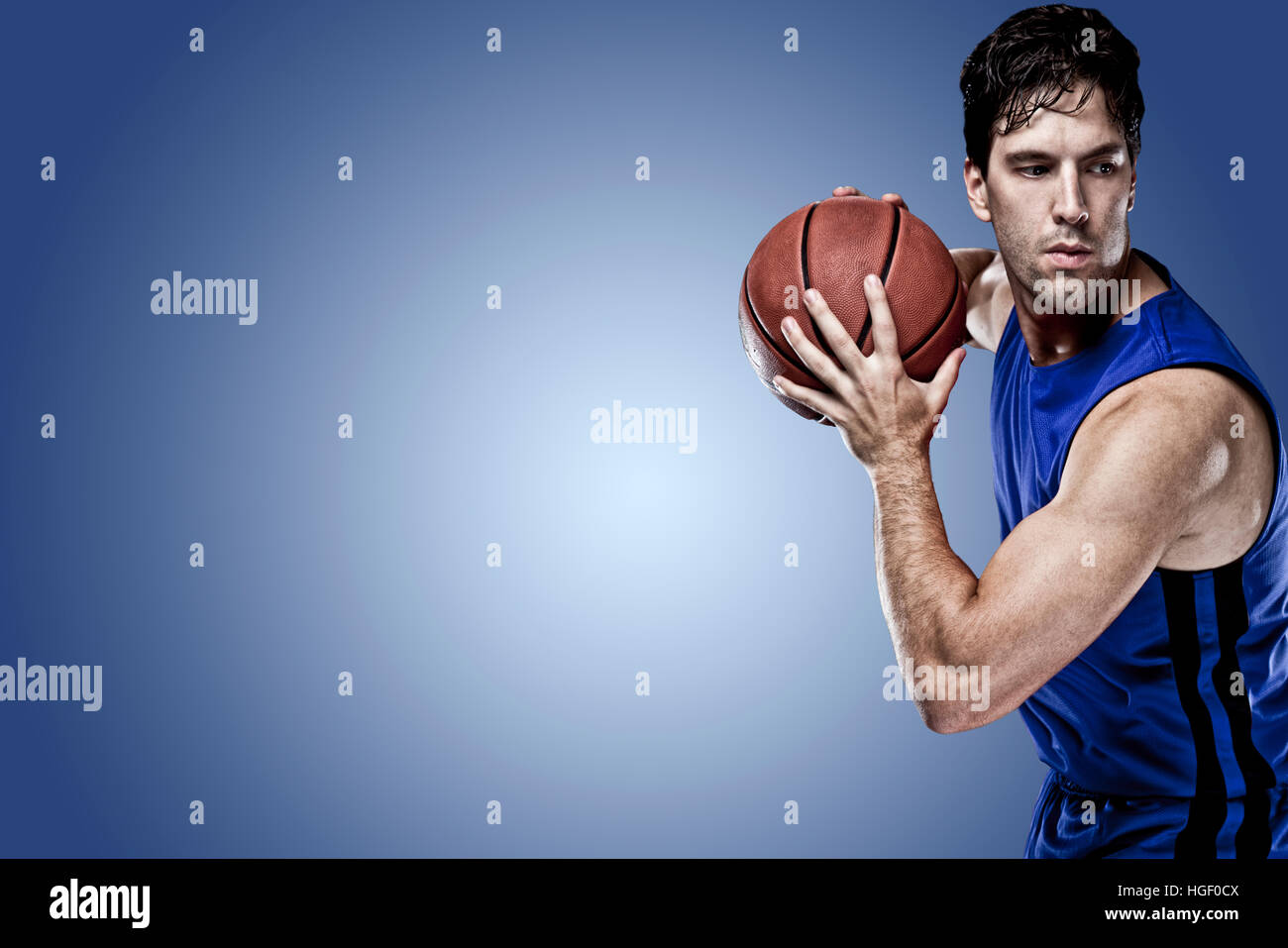 Basketball player on a blue uniform, on a blue background Stock Photo ...