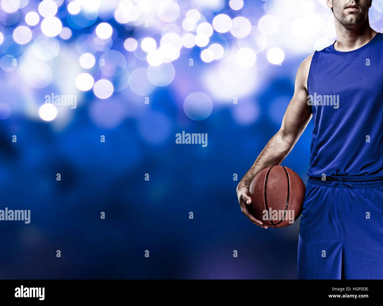 Basketball player on a blue uniform, on a blue lights background Stock ...