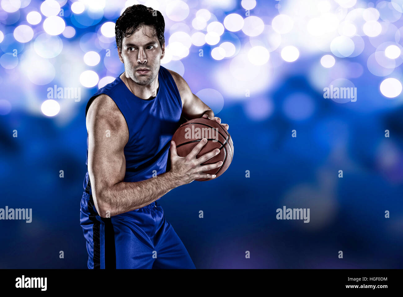 Basketball player on a blue uniform, on a blue lights background Stock ...