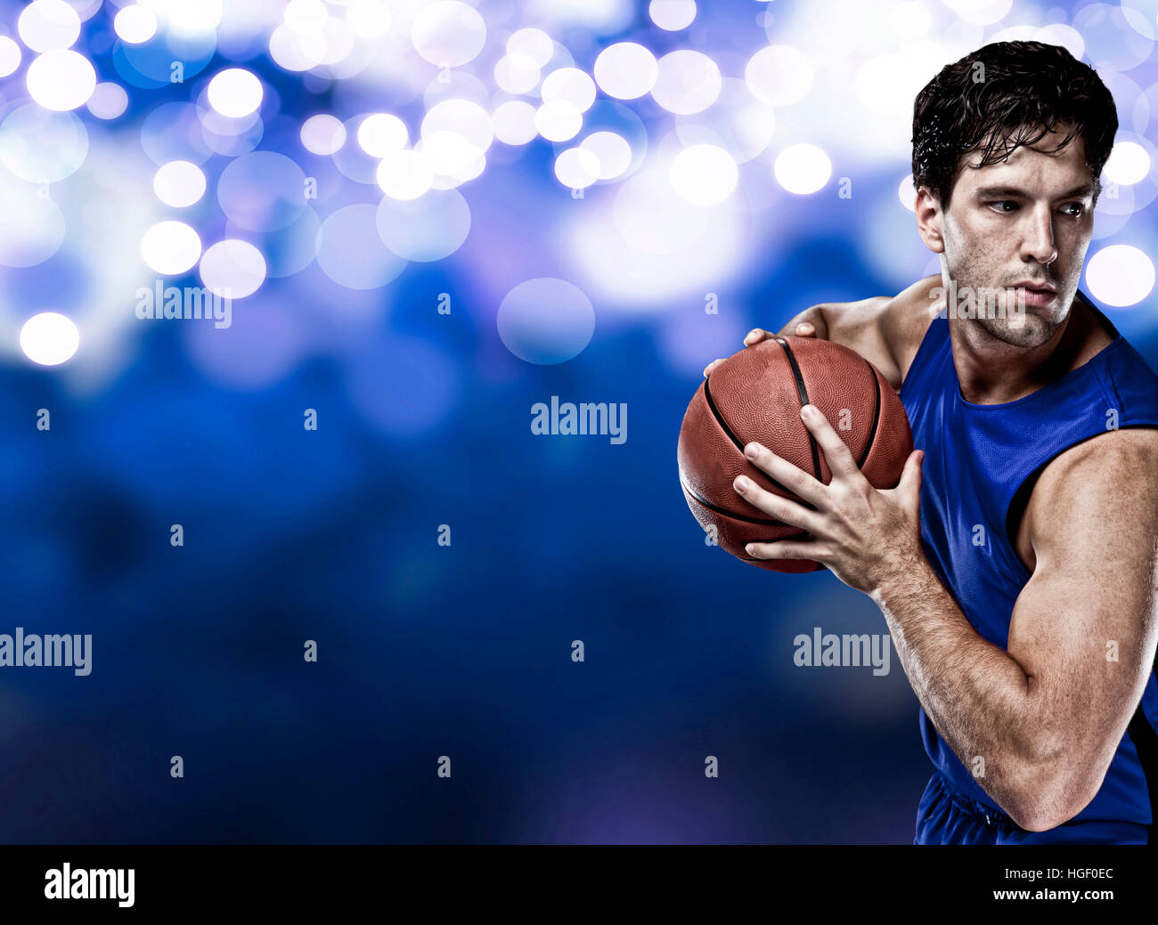 Basketball player on a blue uniform, on a blue lights background Stock ...