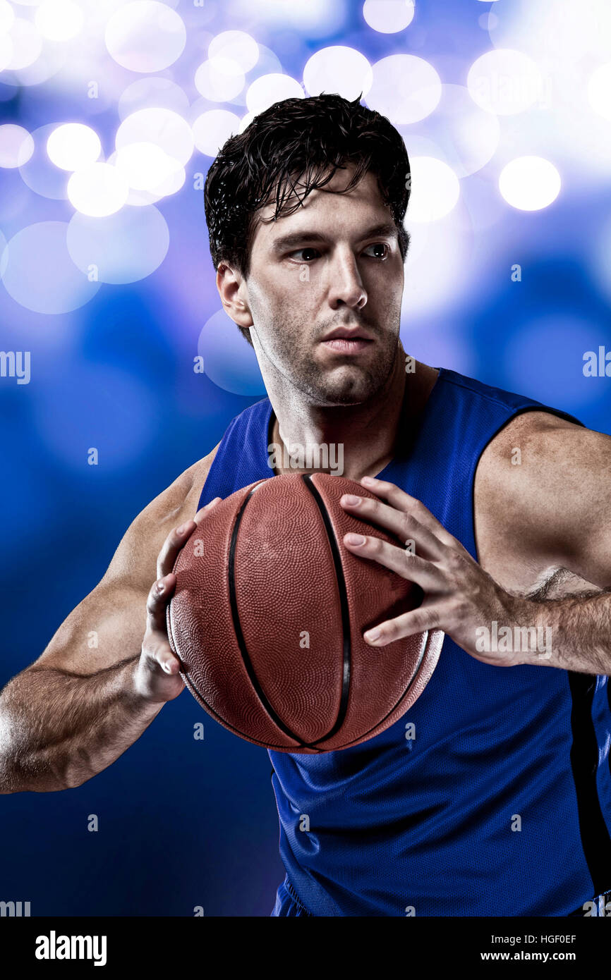 Basketball player on a blue uniform, on a blue lights background Stock ...