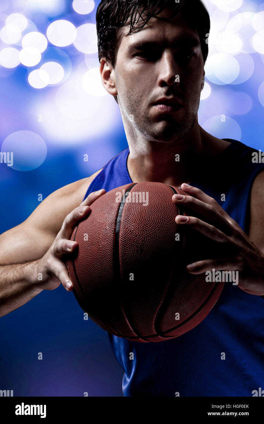 Basketball player on a blue uniform, on a blue lights background Stock ...