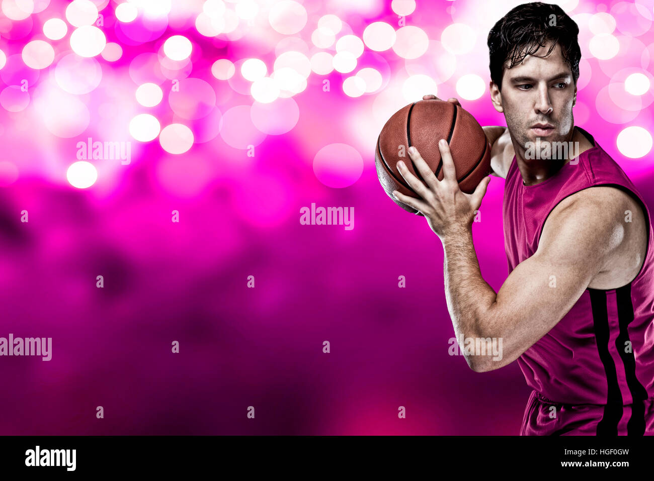 Basketball player on a pink uniform, on a pink lights background Stock ...