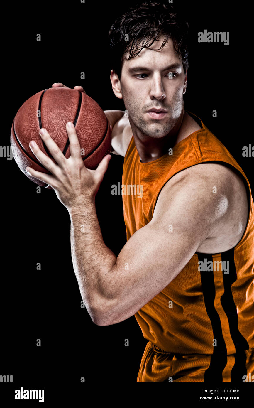 Basketball player on a orange uniform, on a black background Stock ...