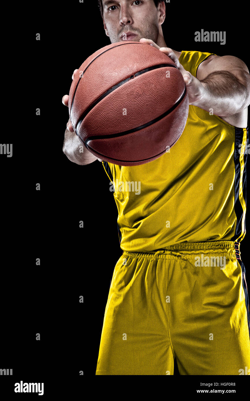 Basketball player on a yellow uniform, on a black background Stock ...
