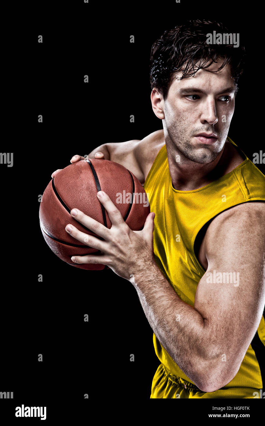 Basketball player on a yellow uniform, on a black background Stock ...