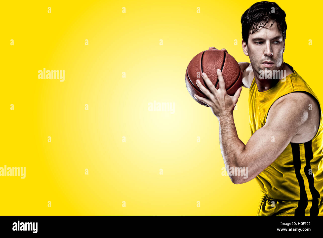 Basketball player on a yellow uniform, on a yellow background Stock ...