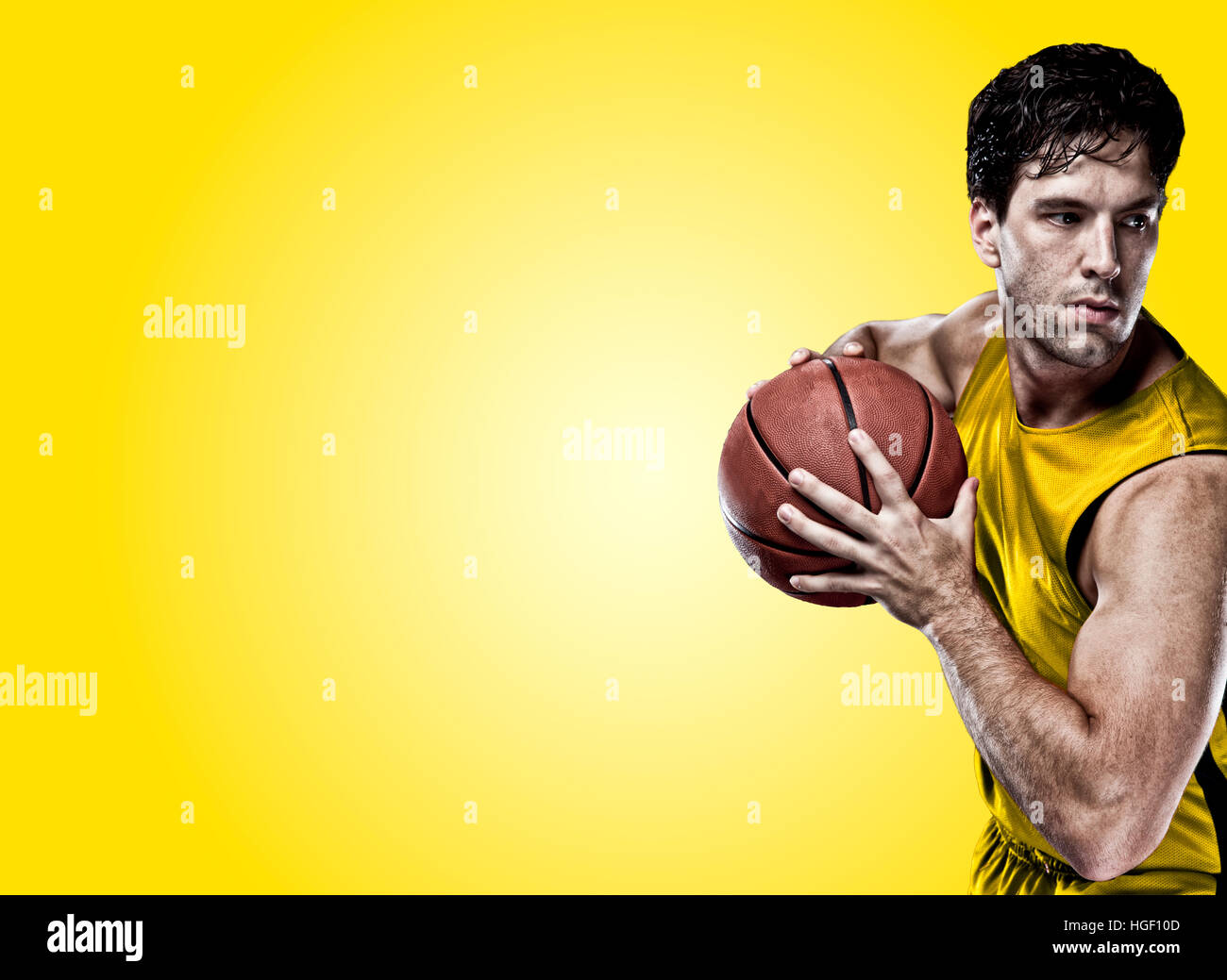 Basketball player on a yellow uniform, on a yellow background Stock ...