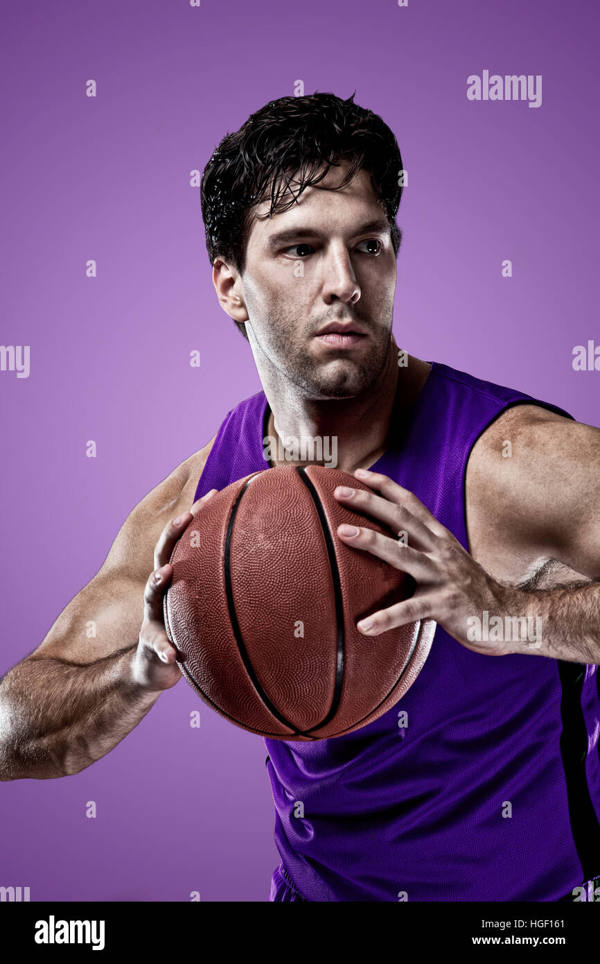 Basketball player on a purple uniform, on a purple background Stock ...