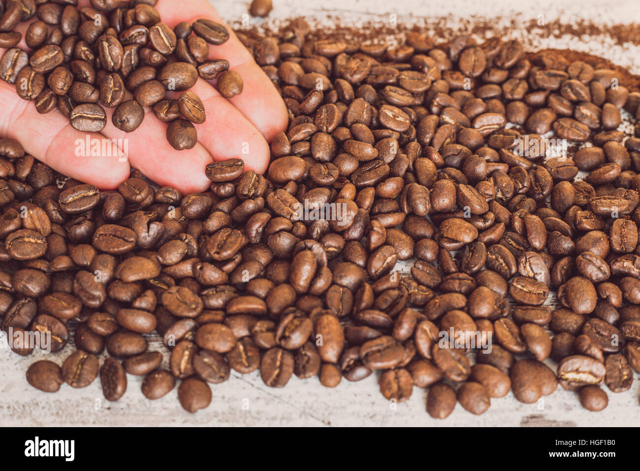 Spilled coffee beans on a table Stock Photo - Alamy