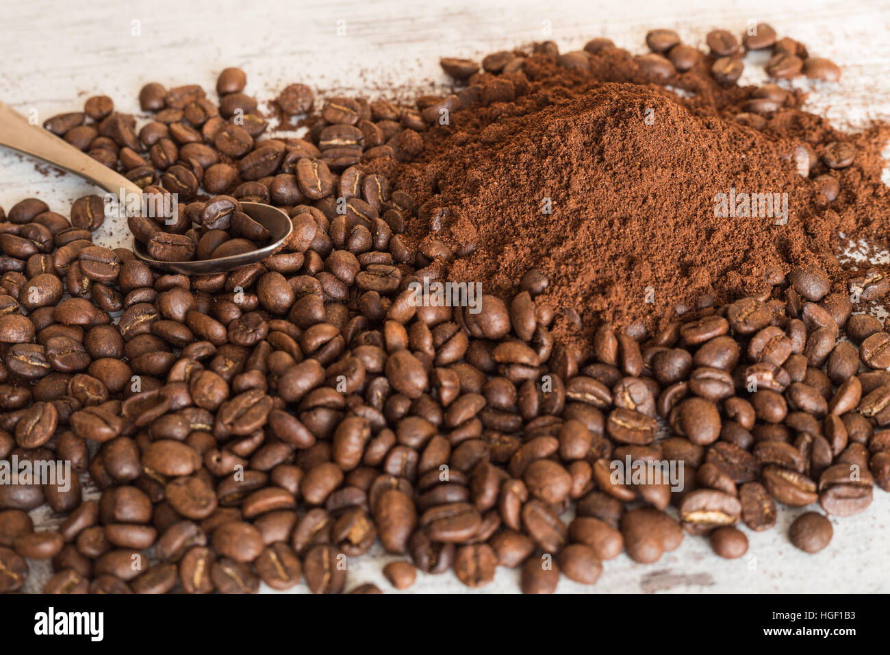 Spilled coffee beans and ground on a table Stock Photo - Alamy