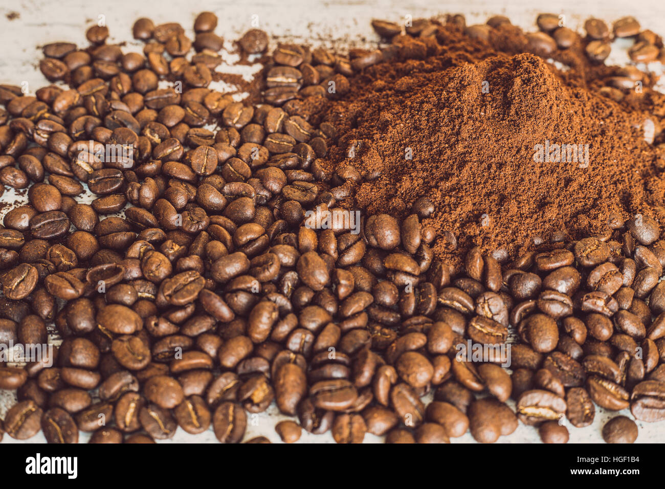 Spilled coffee beans and ground on a table Stock Photo - Alamy