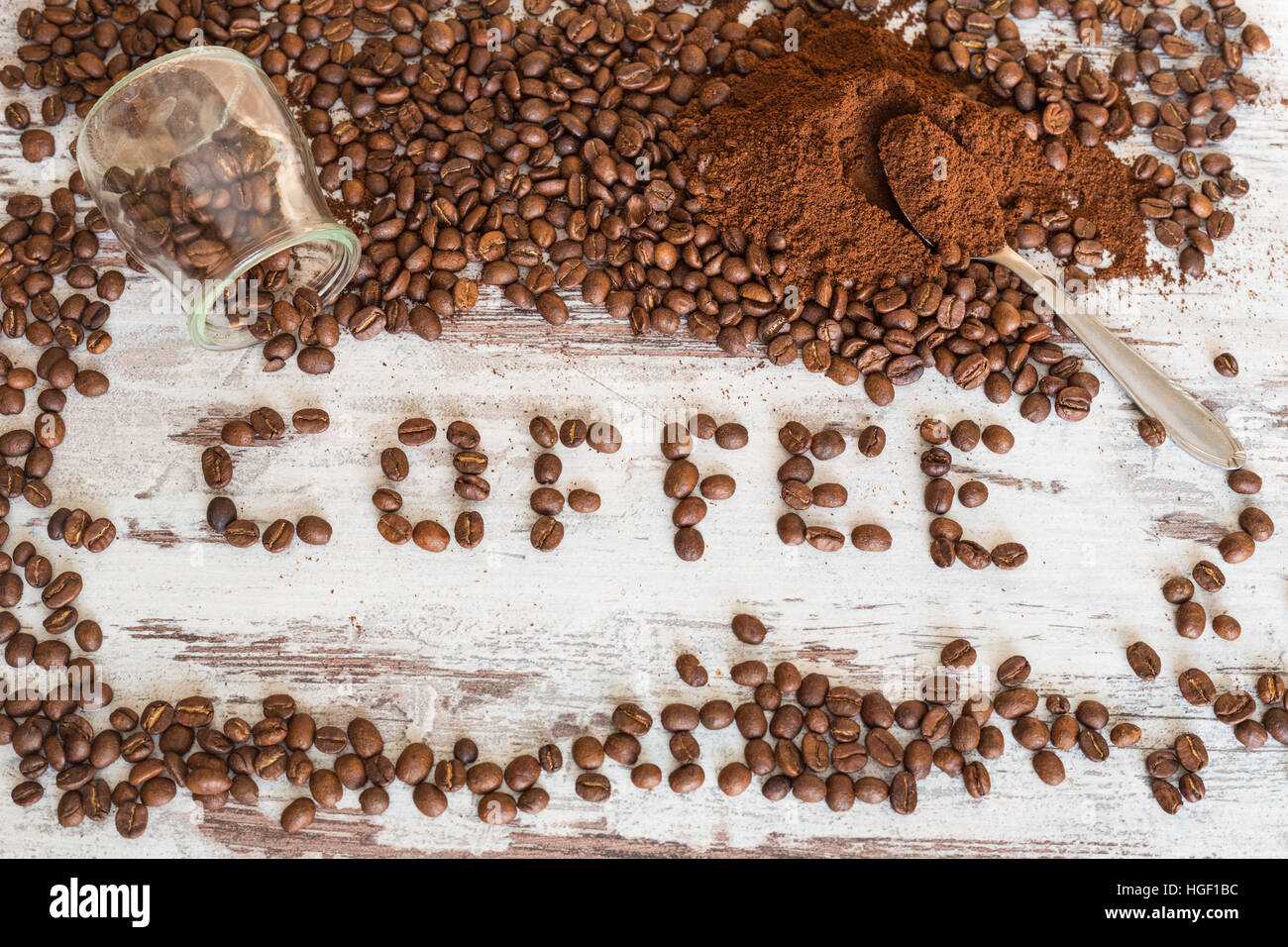 Spilled coffee beans and ground on the table and write coffee Stock ...