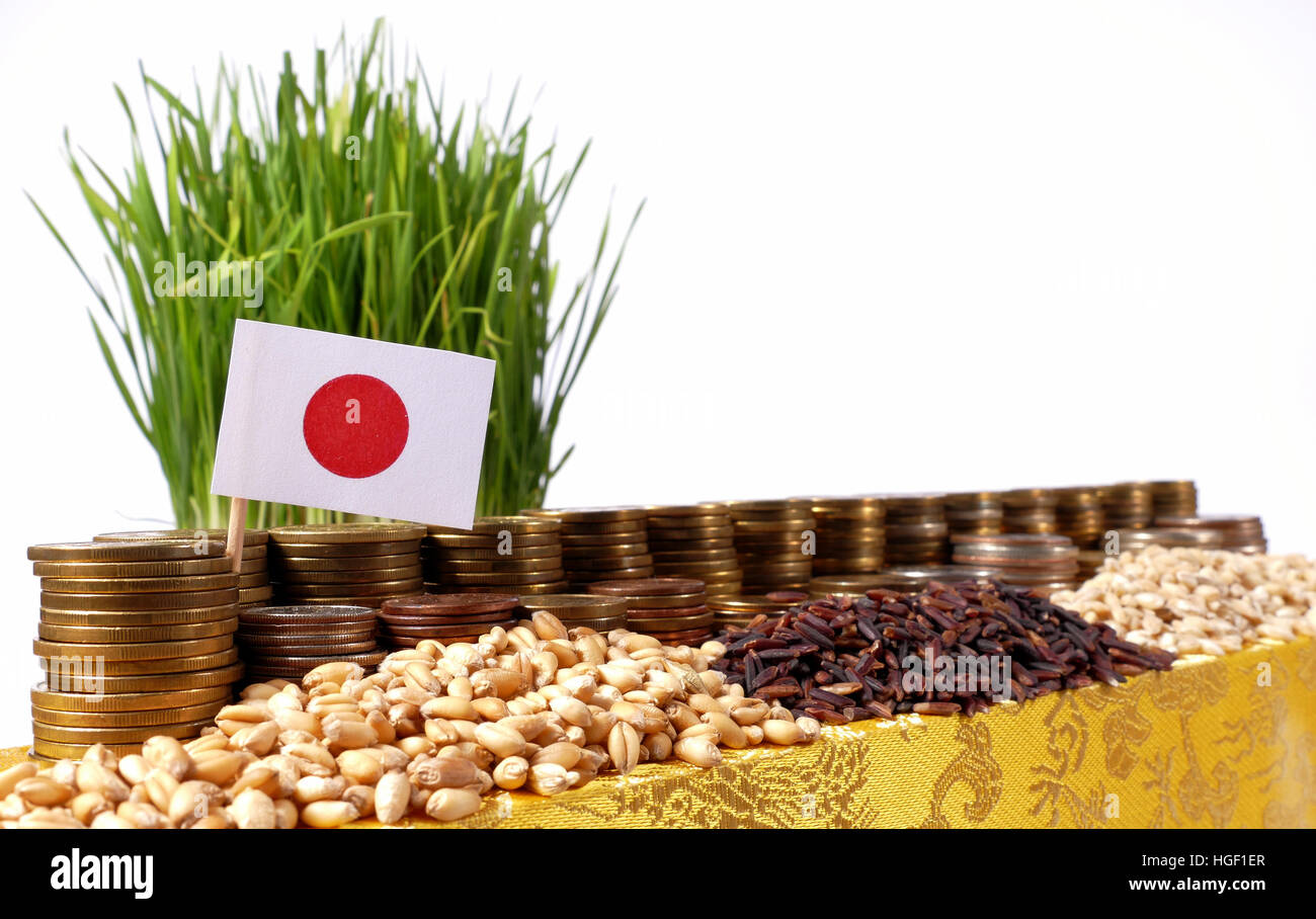 Japan flag waving with stack of money coins and piles of wheat and rice ...