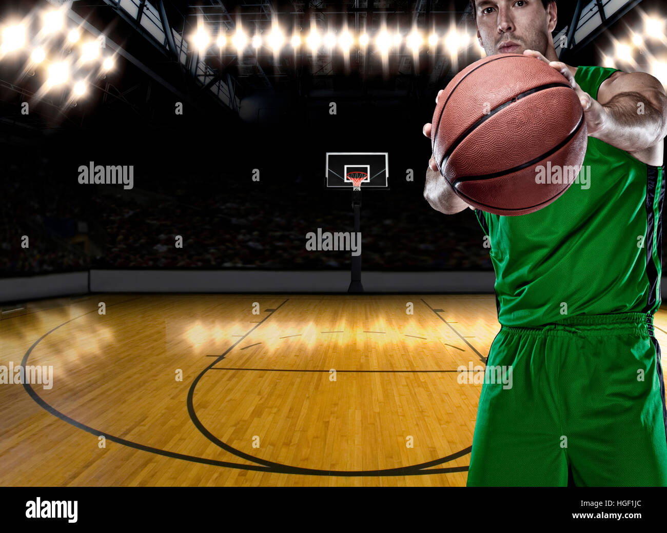 Basketball player on a green uniform, on a basketball court Stock Photo ...