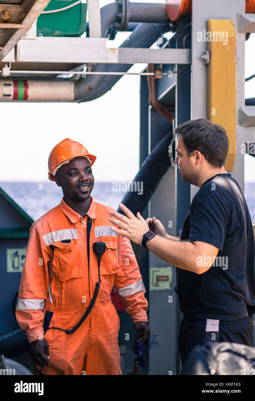 friendship of nations on board of ship/vessel. European Chief officer ...