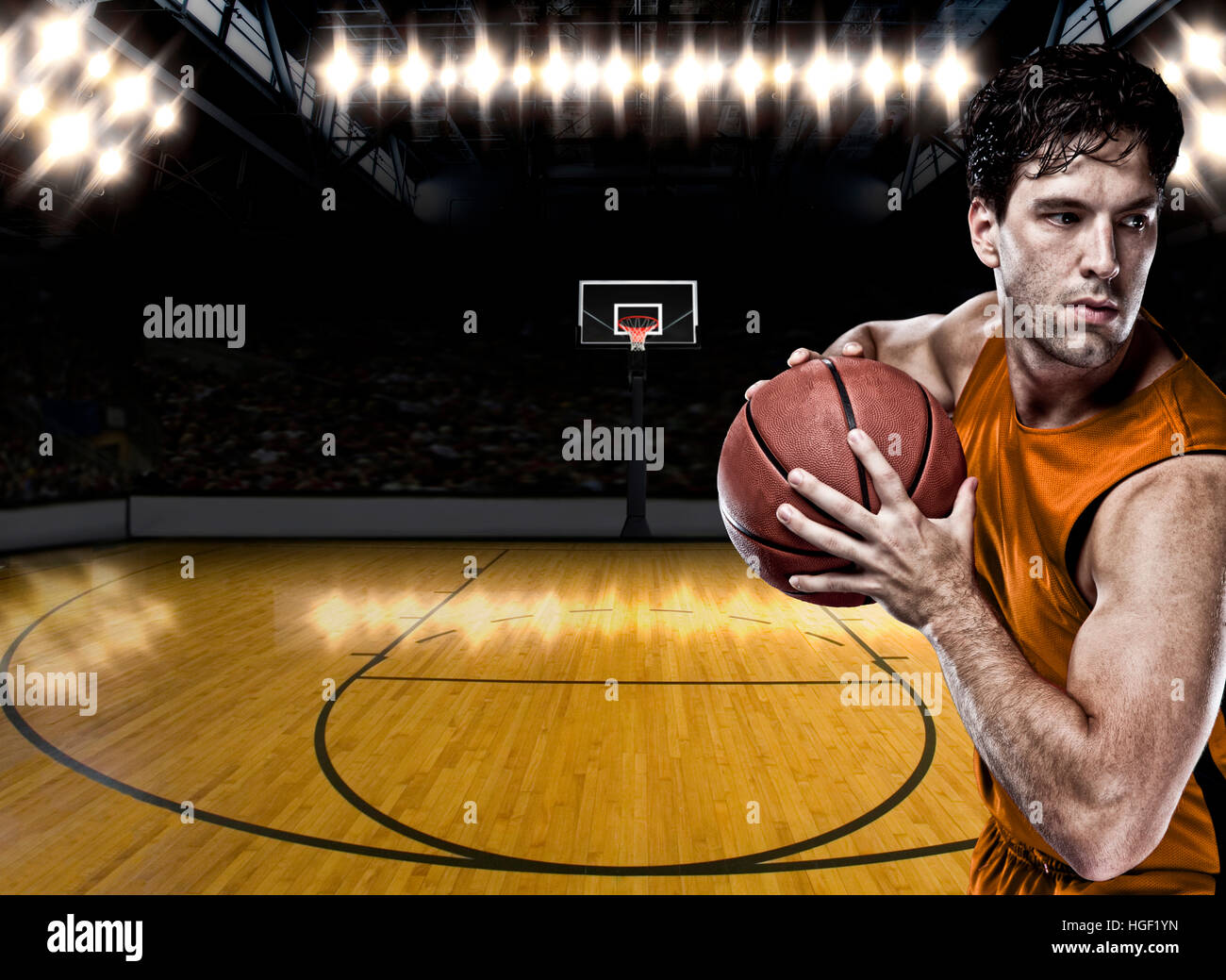 Basketball player on a orange uniform, on a basketball court Stock ...
