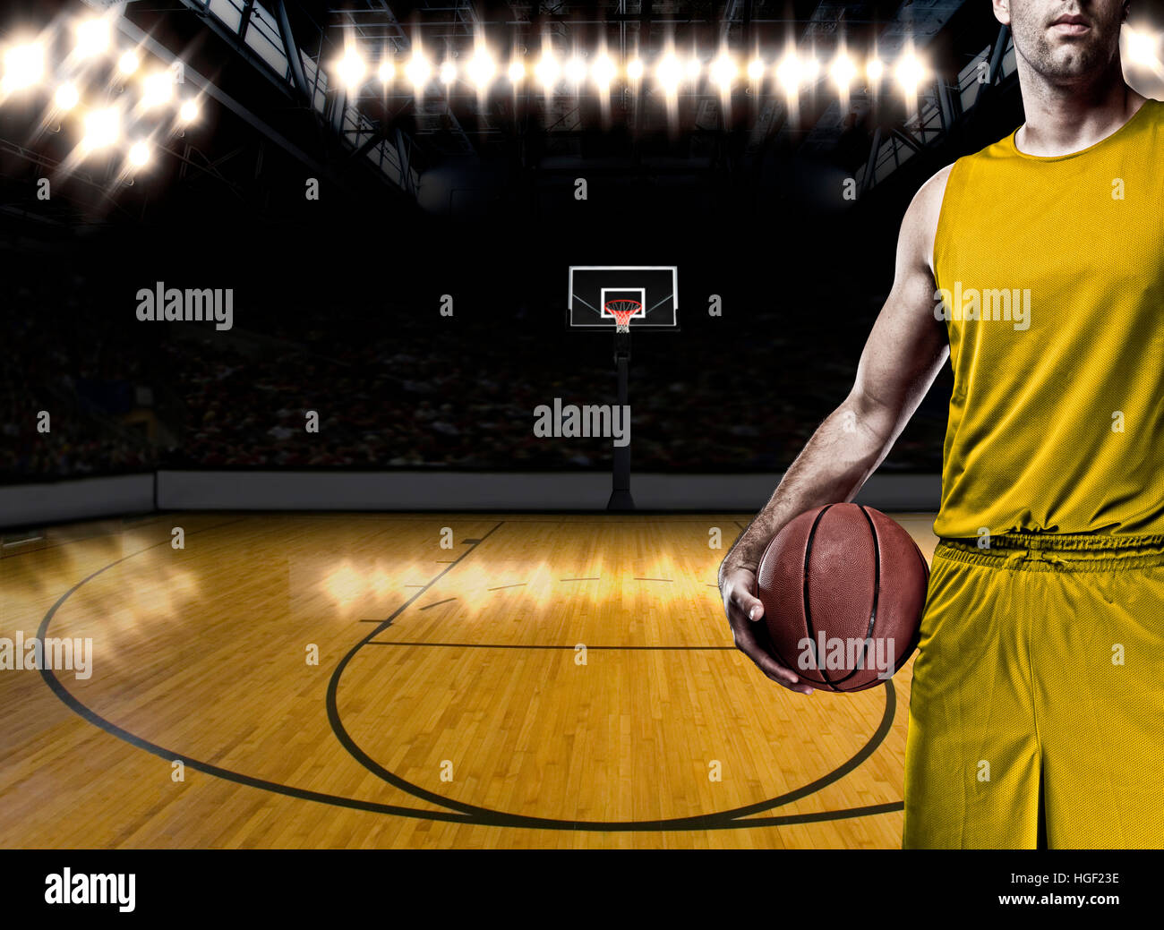 Basketball player on a yellow uniform, on a basketball court Stock ...
