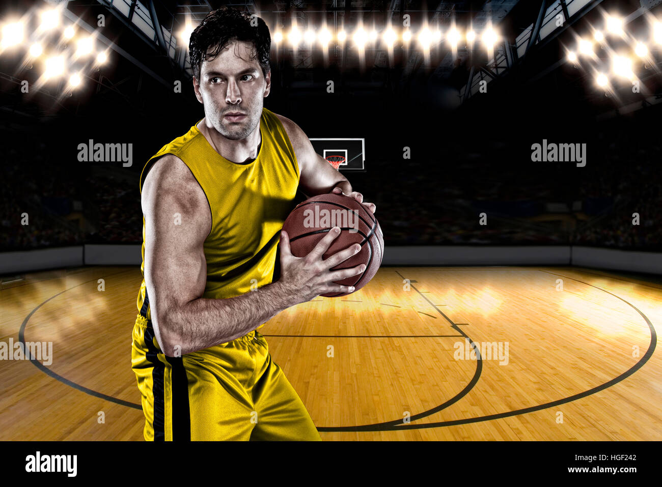 Basketball player on a yellow uniform, on a basketball court Stock ...