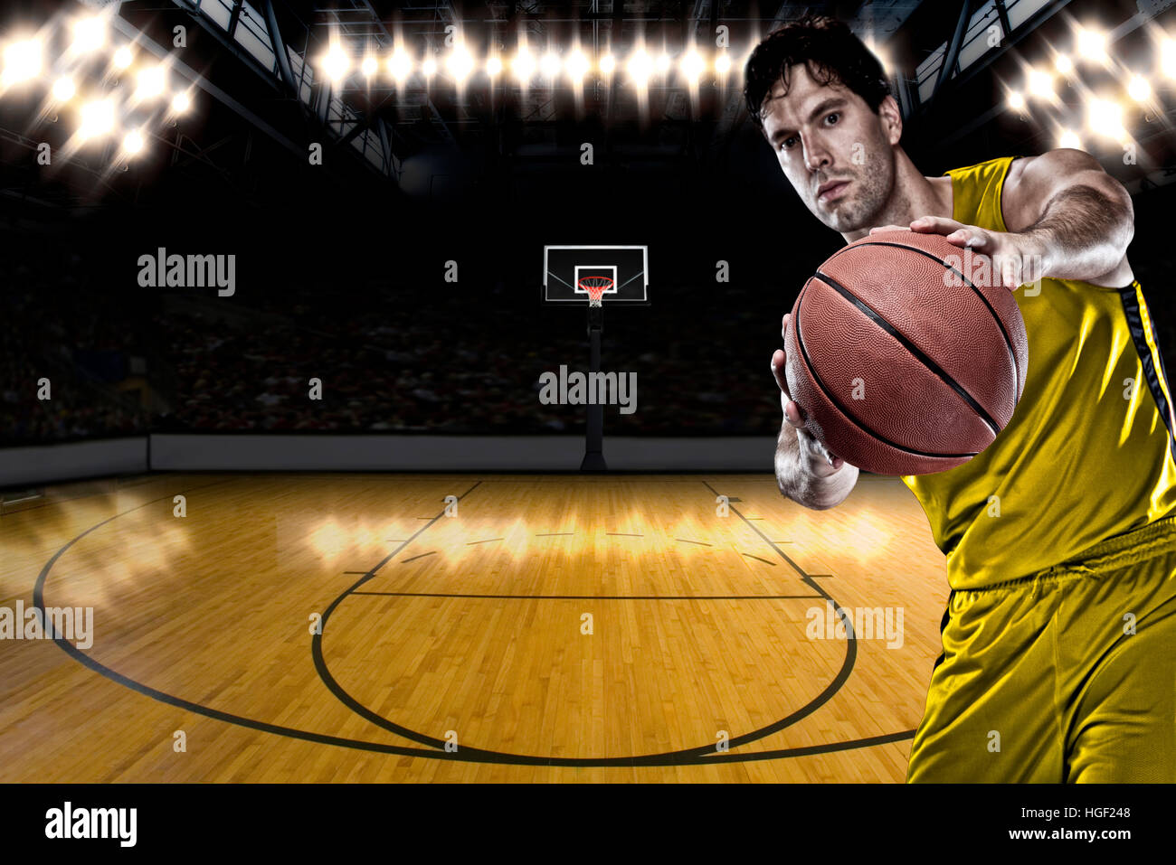 Basketball player on a yellow uniform, on a basketball court Stock ...