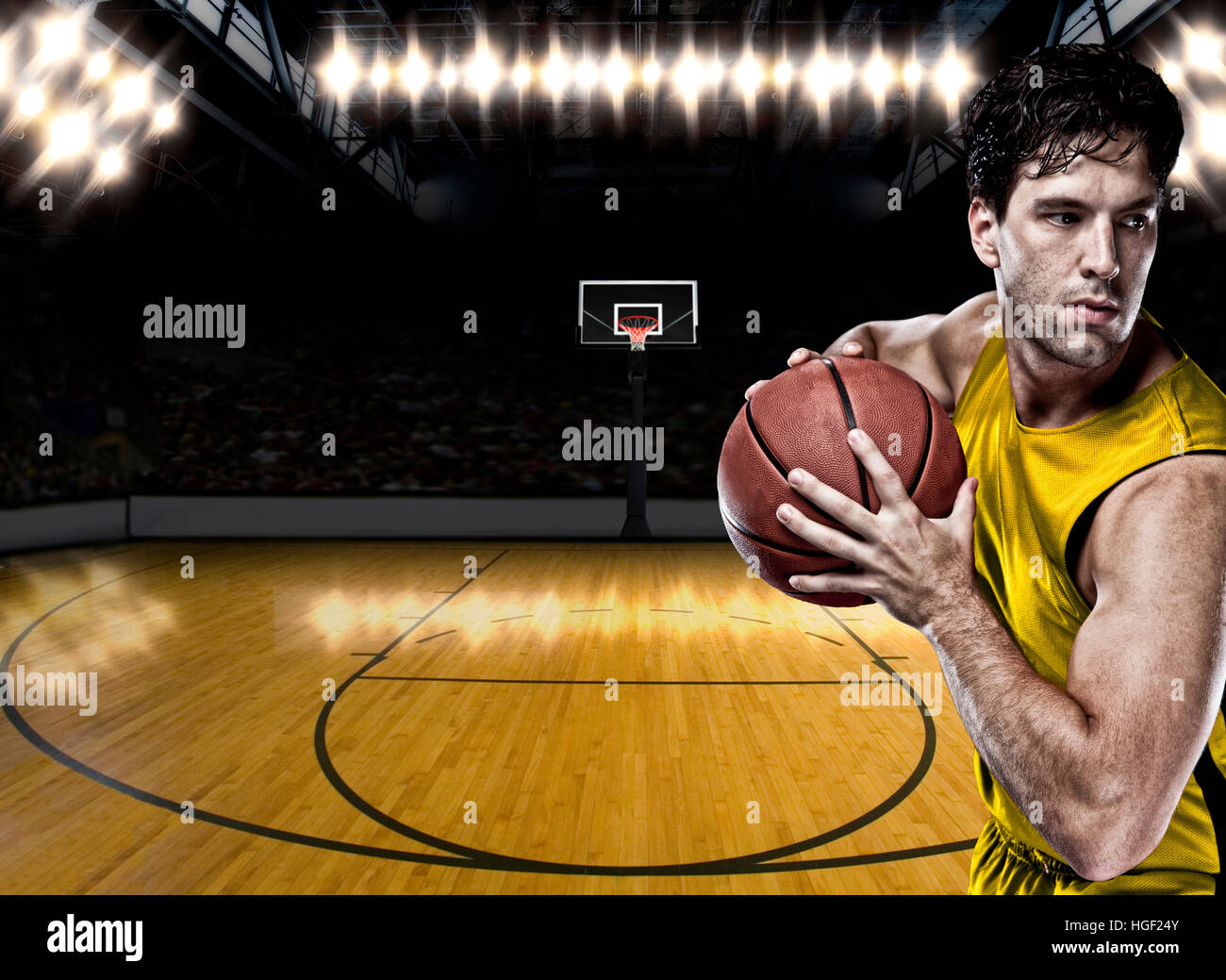 Basketball player on a yellow uniform, on a basketball court Stock ...