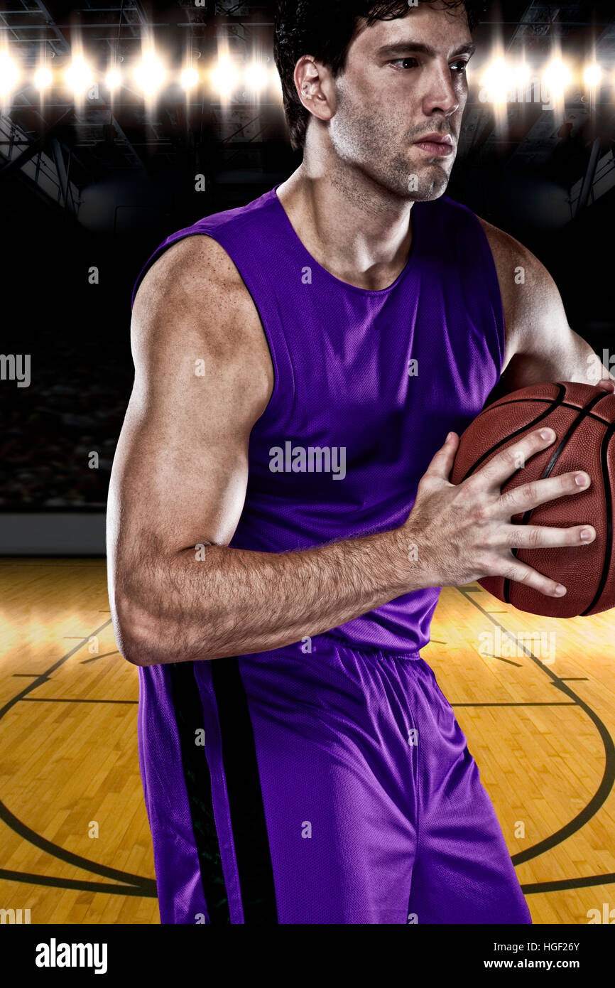 Basketball player on a purple uniform, on a basketball court Stock ...