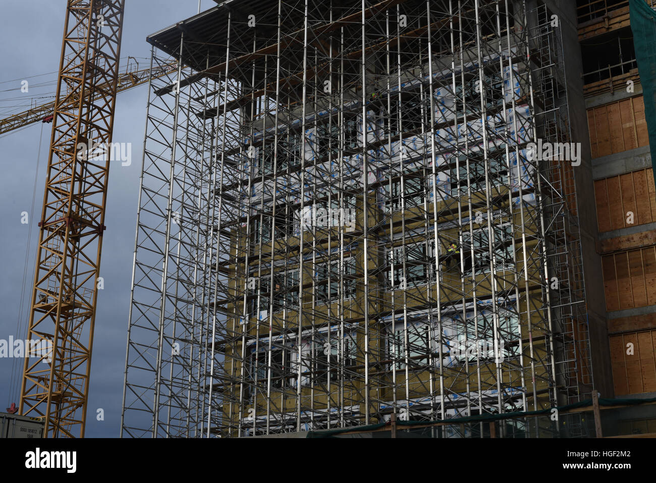 Scaffolding covers a commercial and residential building under ...
